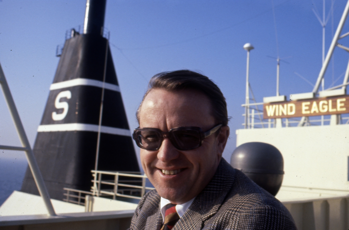 Rederen poserer på brovingen på T/T ‘Wind Eagle’ (b. 1977, Kockums Varv ...